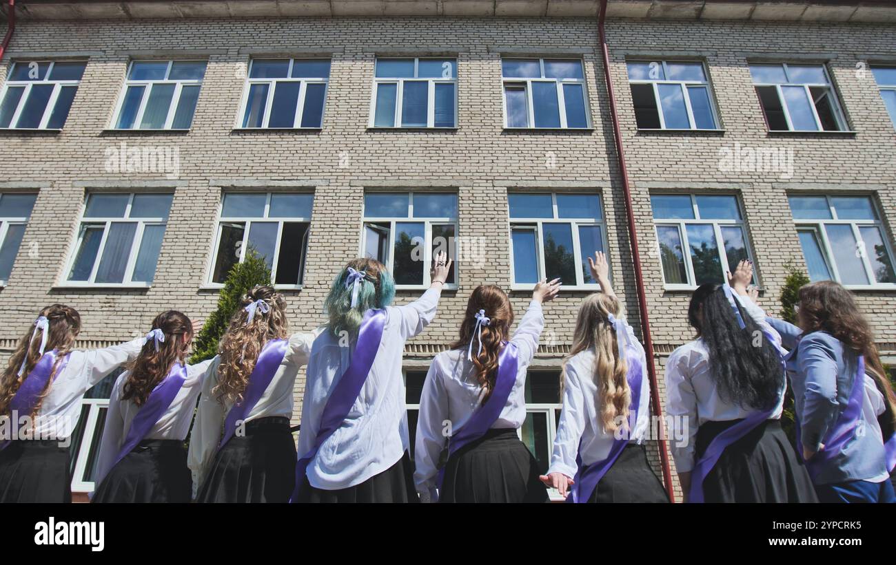 Graduating students bidding farewell to their school, marking the ...