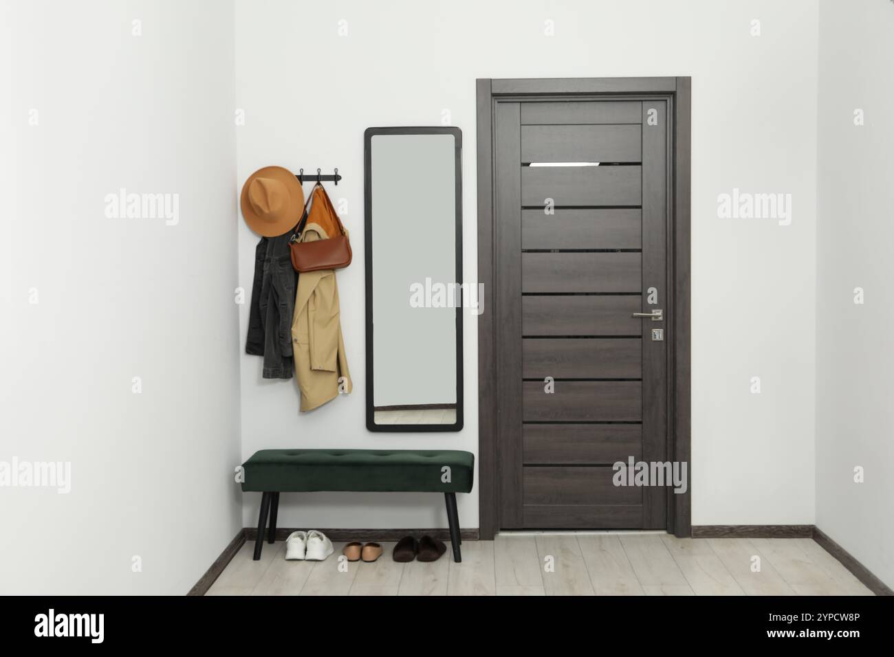 Mirror, rack with clothes and bench in hallway. Interior design Stock ...
