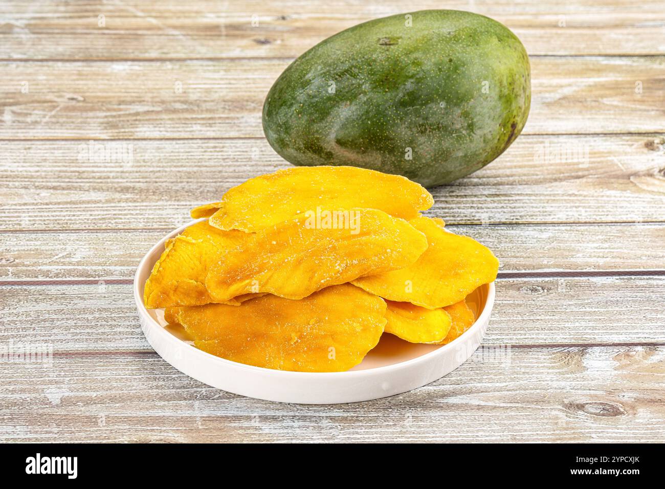 Dry sweet yellow mango snack in the plate Stock Photo - Alamy