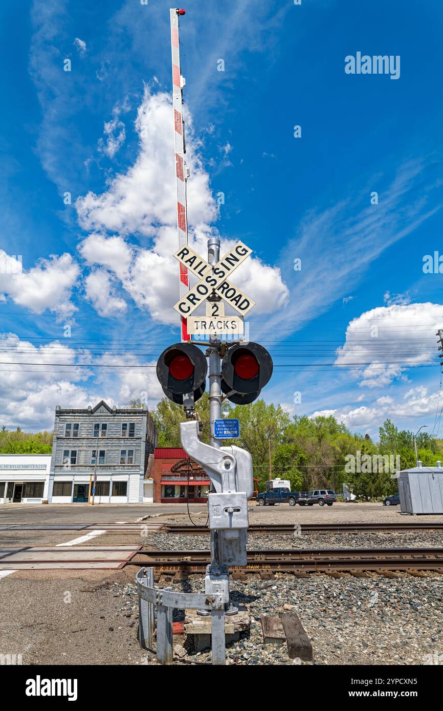 An open railroad crossing arm at the tracks in downtown Shoshone, Idaho ...