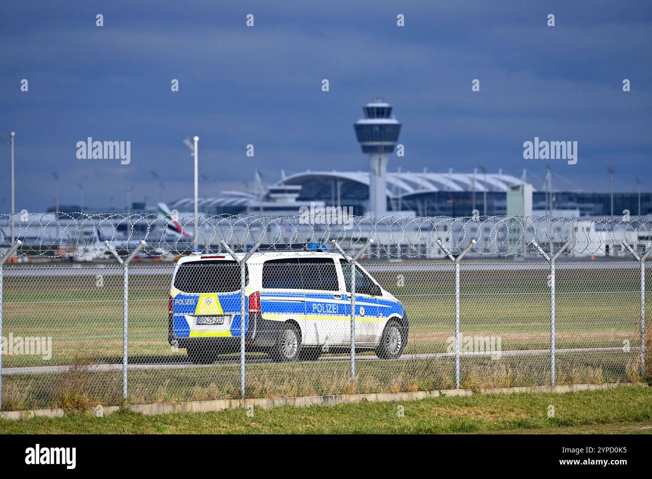 Police vehicle patrols and checks the fence, safety fence at Franz ...