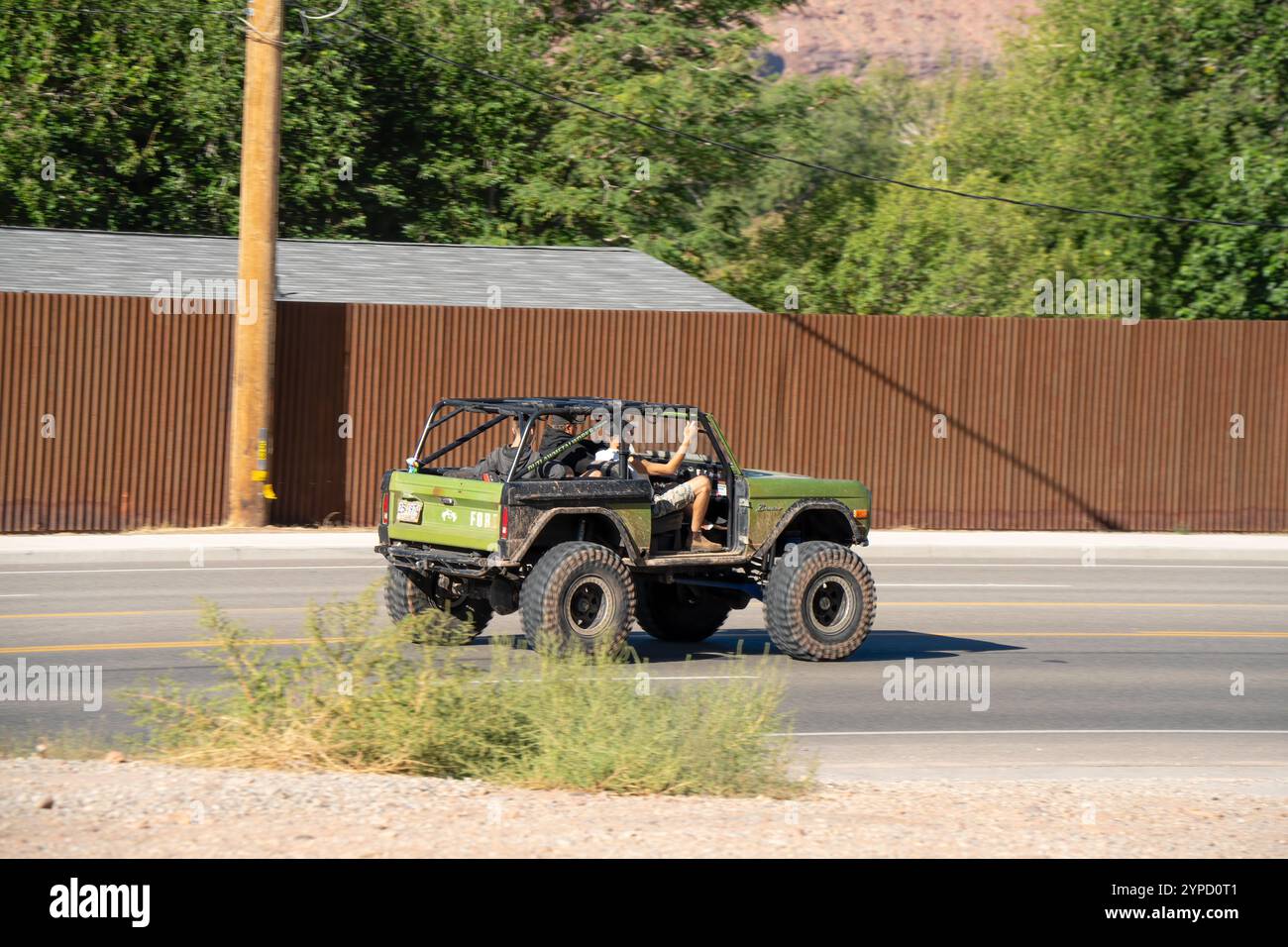 large american off-road open-top green 4x4 moving along a highway Stock ...