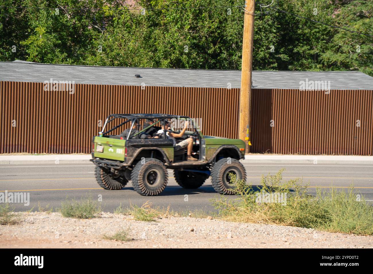 large american off-road open-top green 4x4 moving along a highway Stock ...
