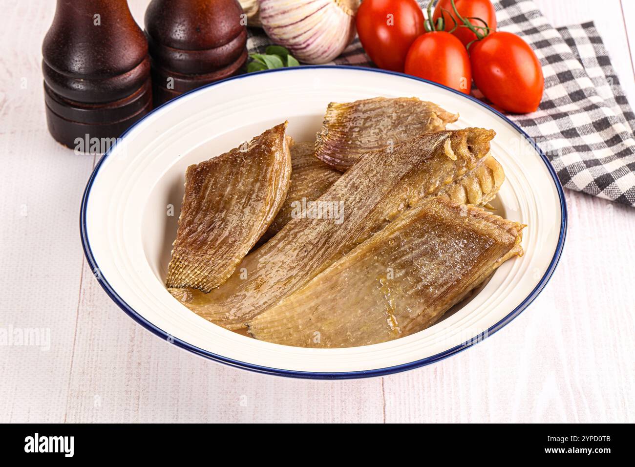 Baked stingray witngs with oil and spices Stock Photo - Alamy