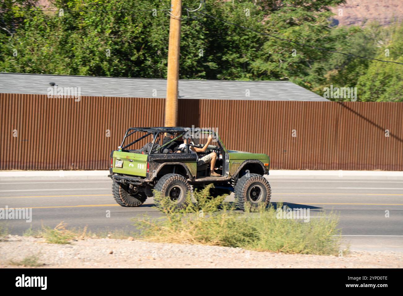 large american off-road open-top green 4x4 moving along a highway Stock ...