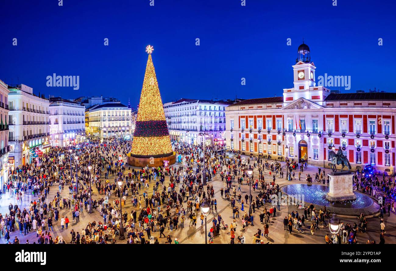 Puerta del Sol square at nightfall illuminated by christmas lights and ...