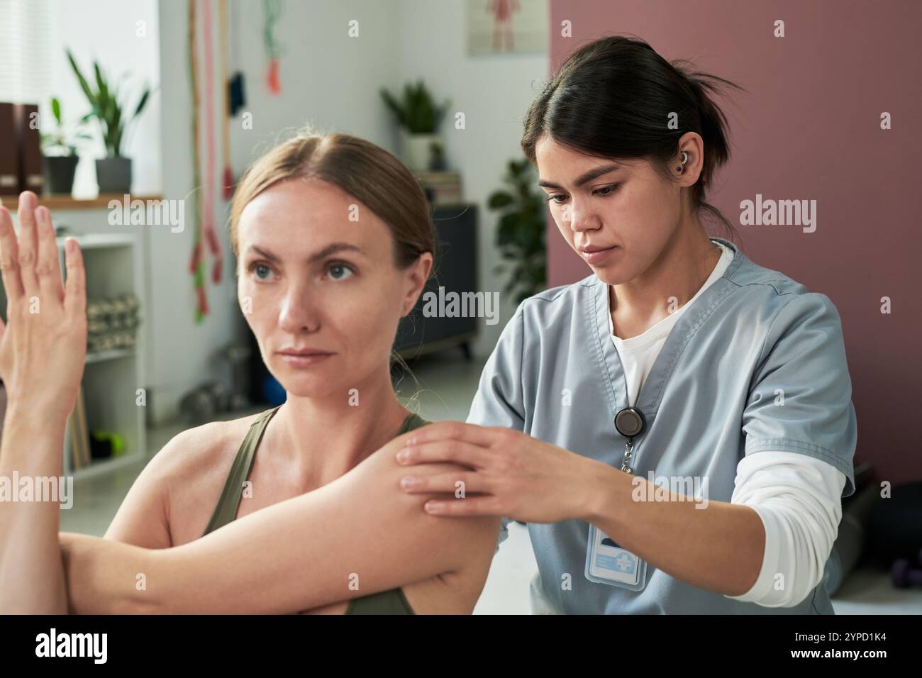 Physical therapist providing an exercise routine to a female patient ...
