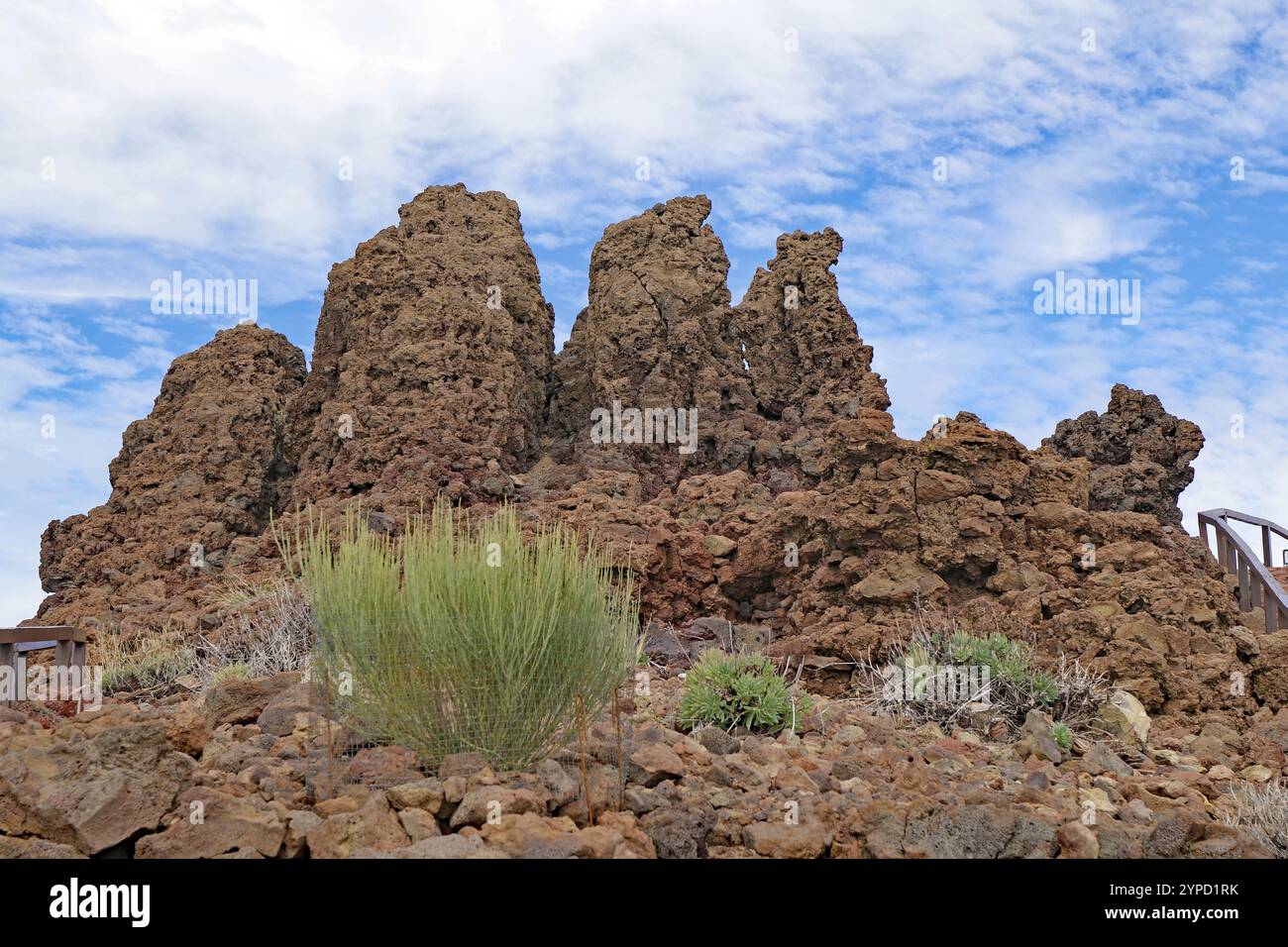 Brown rocks rise into a cloudy desert landscape, Roques de los Muchachos, La Palma, Canary ...
