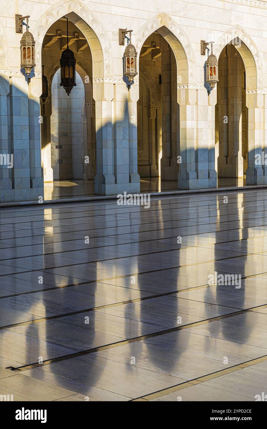 Arched gates with brass lights at the Sultan Qaboos Mosque, Muscat ...