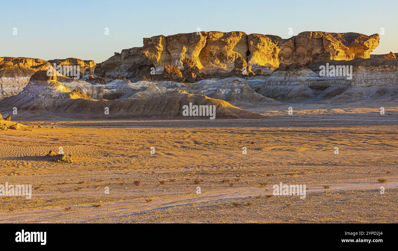 Eroded rock formations on a fossilised reef edge, at blue hour, Huqf ...