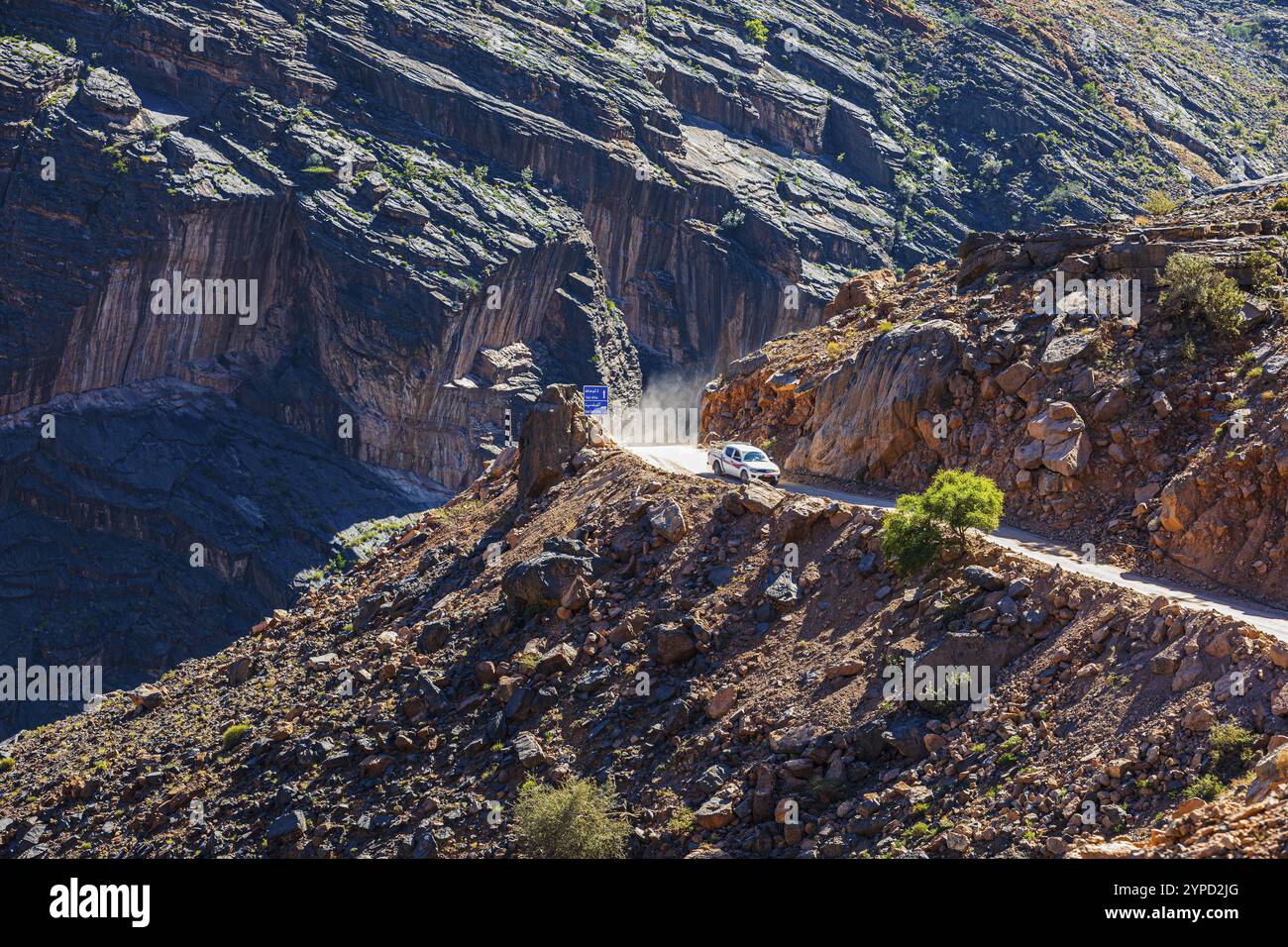 A vehicle crosses an unpaved pass road near the village of Hat, Wadi ...