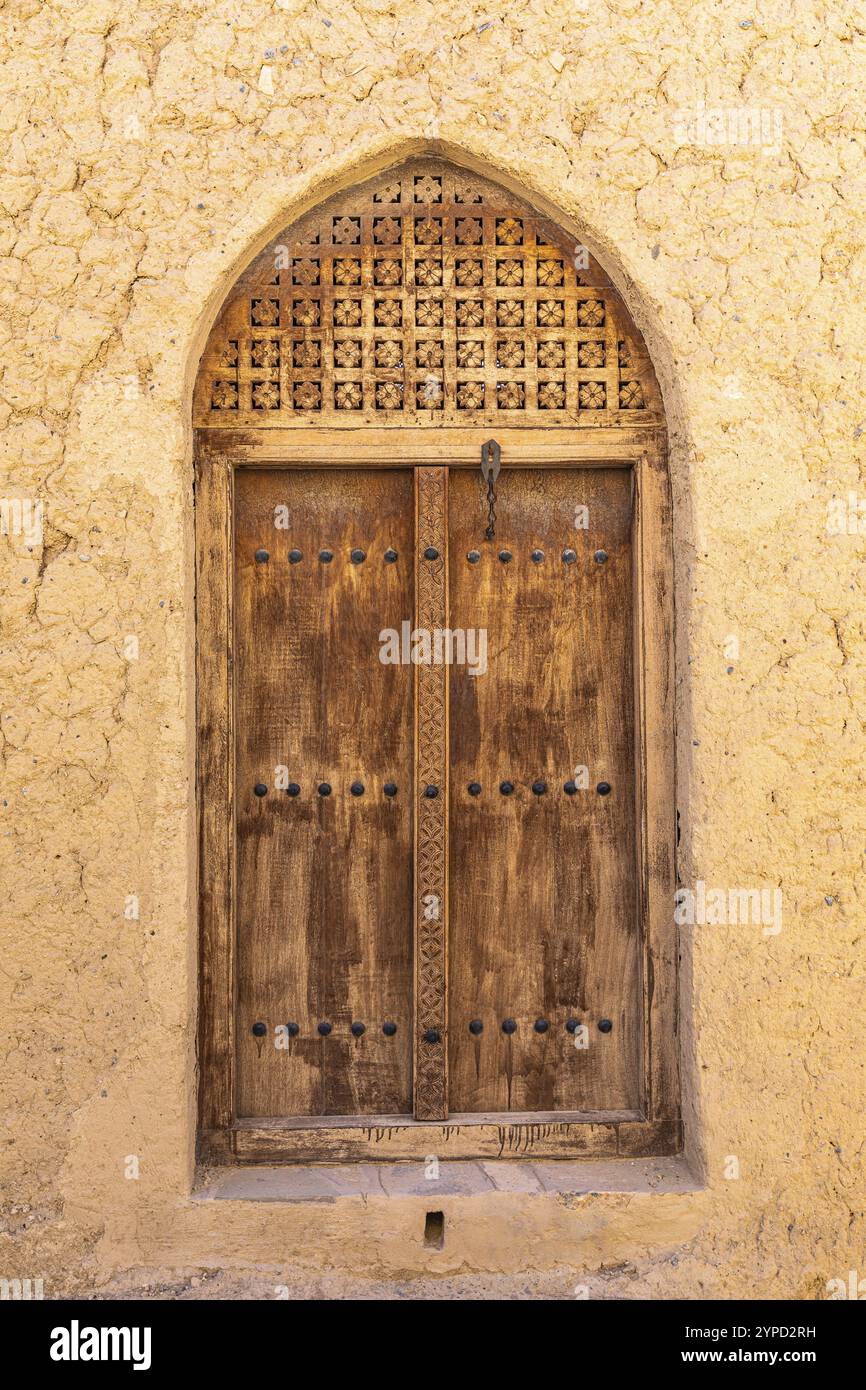 Decorated round arch entrance door in the largest preserved mud town in ...
