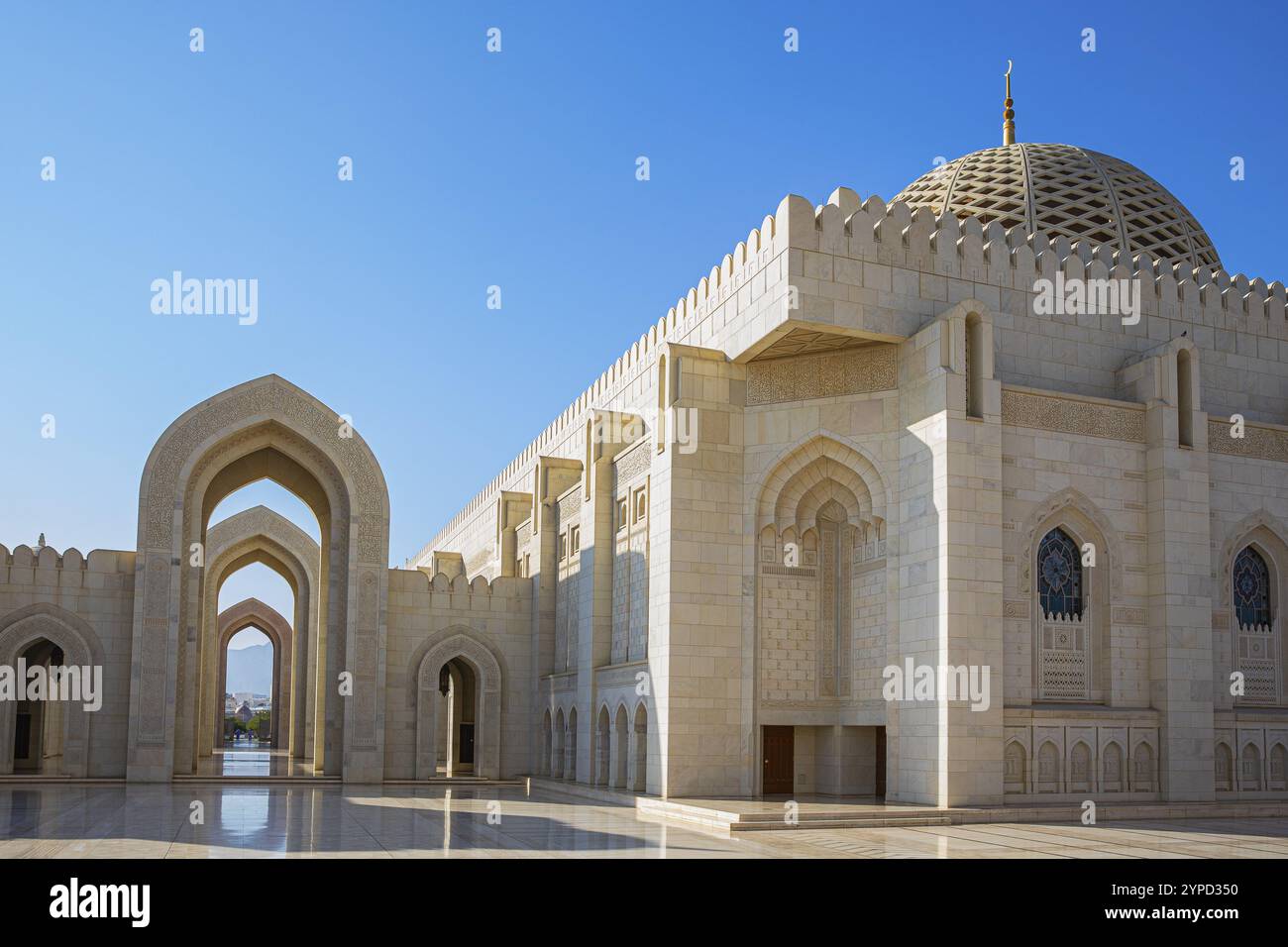 Arched gates and large hall with dome of the Sultan Qaboos Mosque ...
