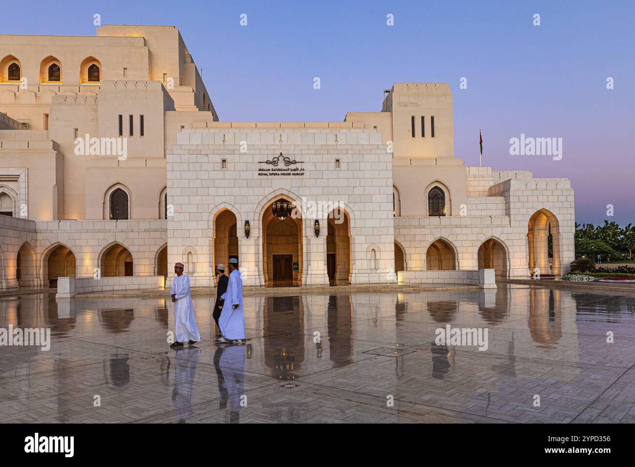 Local men walk across the main square in front of the Royal Opera at ...