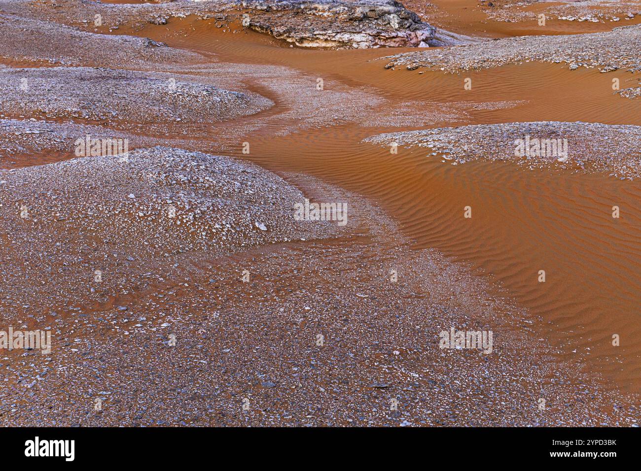 Striking rocks and gravel surrounded by windswept sand structures, Huqf ...