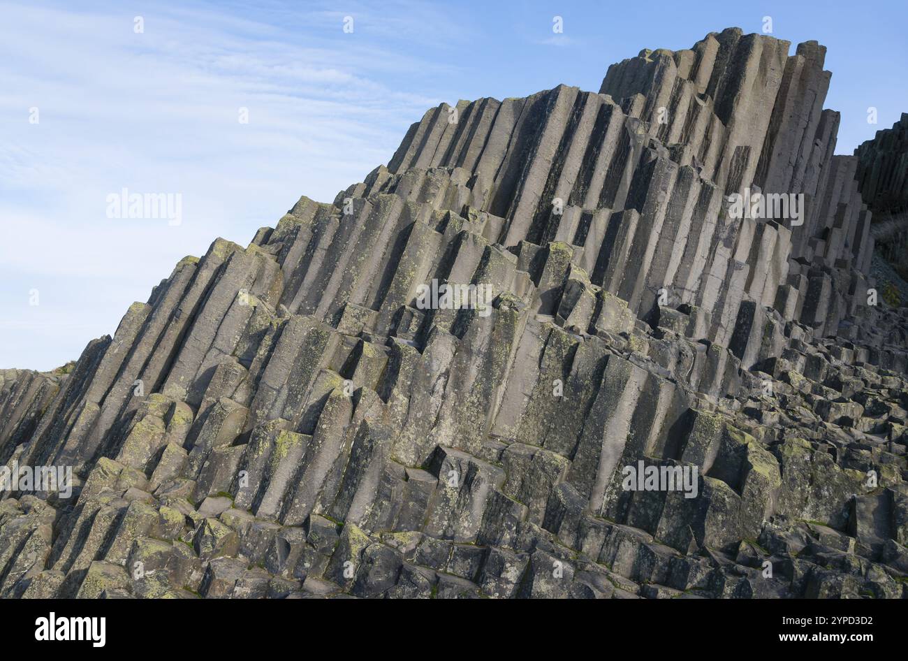 Large basalt columns rise into the sky and form a breathtaking rock formation, manor house rock ...