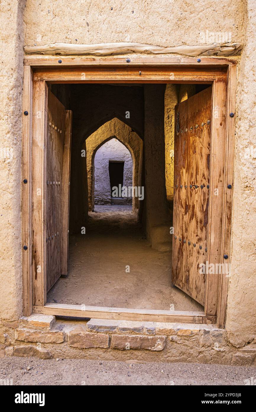 View through an entrance door in the largest preserved mud town in Oman ...