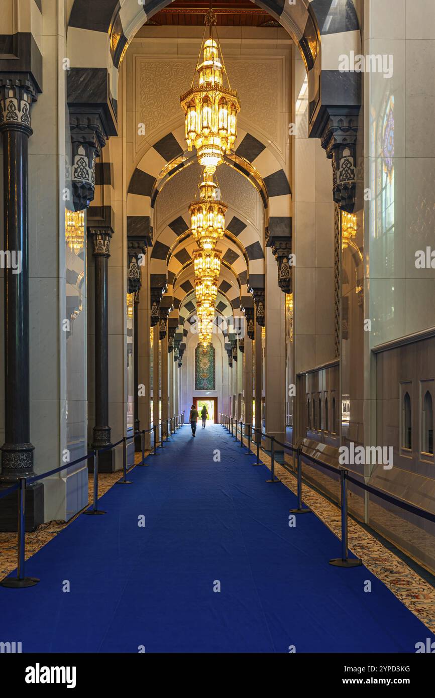 Side corridor with illuminated chandeliers in the Sultan Qaboos Mosque ...