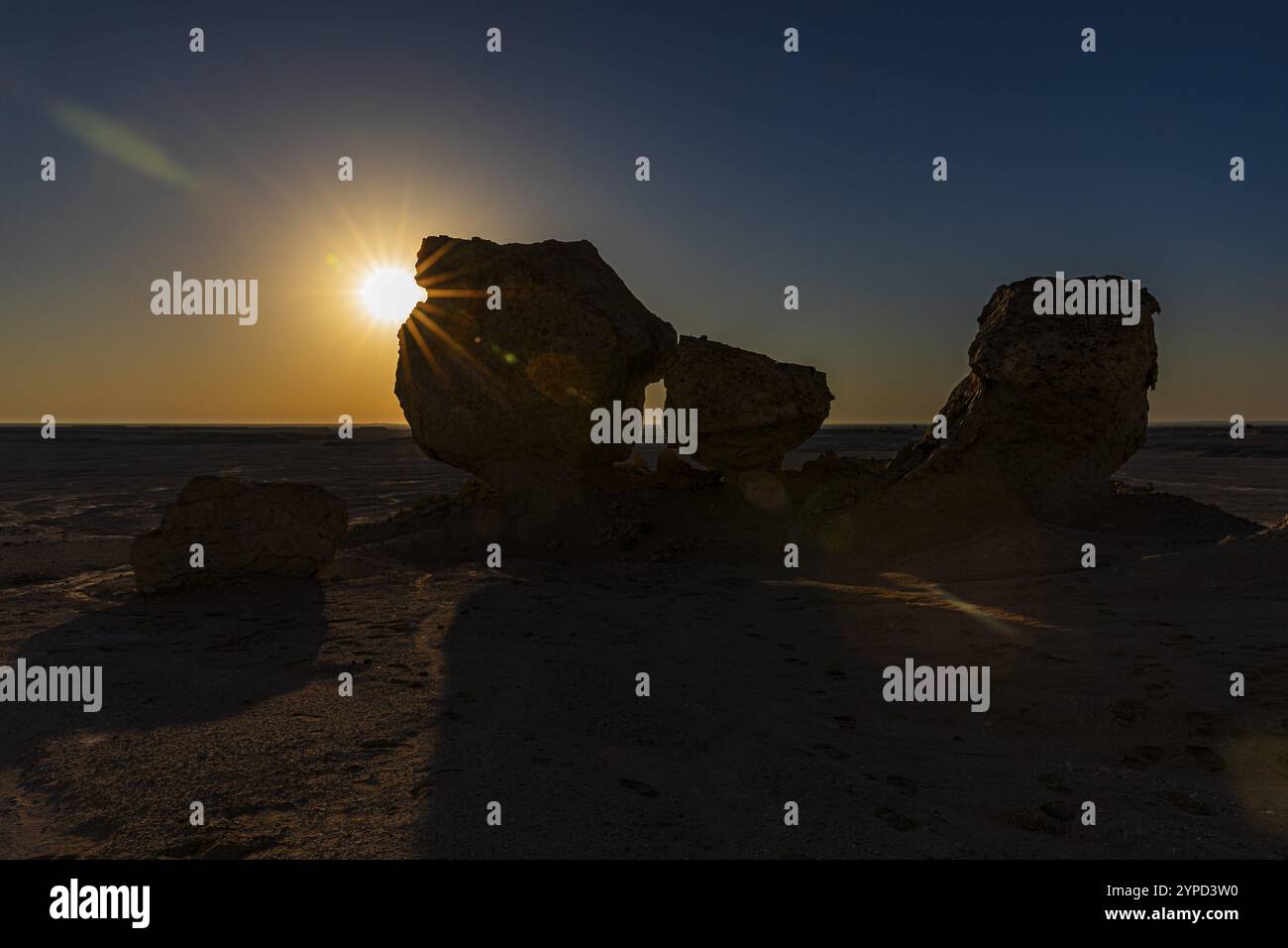 The morning sun shines through a striking rock formation in the Huqf ...