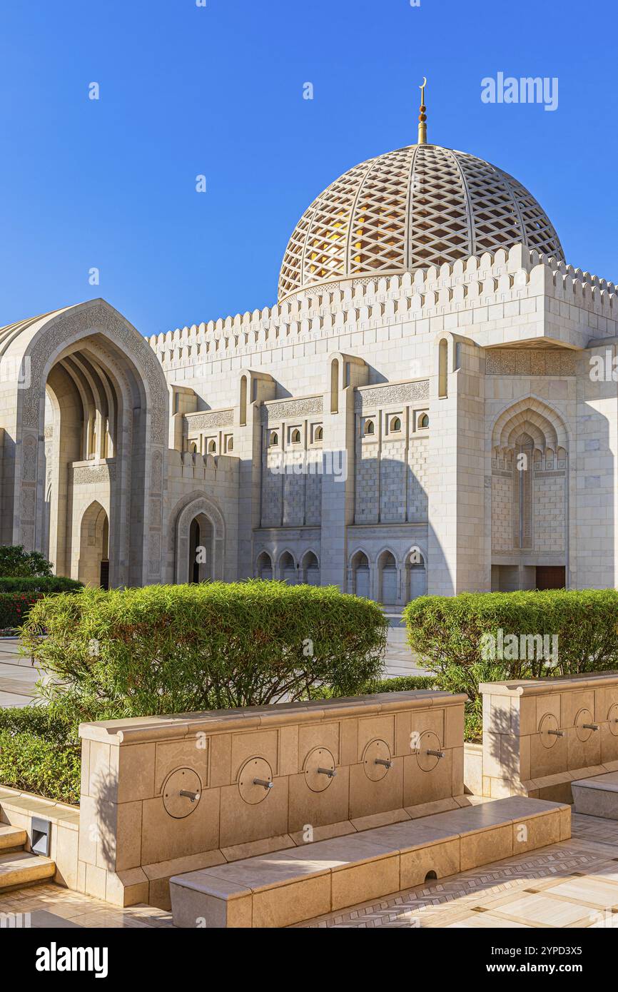 Great hall with dome of the Sultan Qaboos Mosque, in front of it water ...