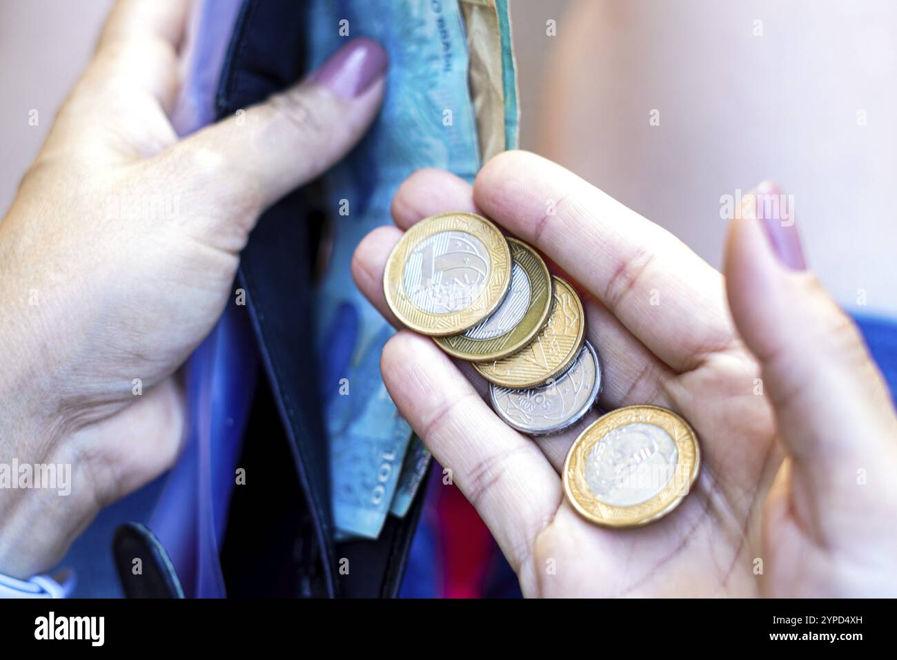 April 19, 2024, Brazil. Woman keeps some real coins in her wallet ...