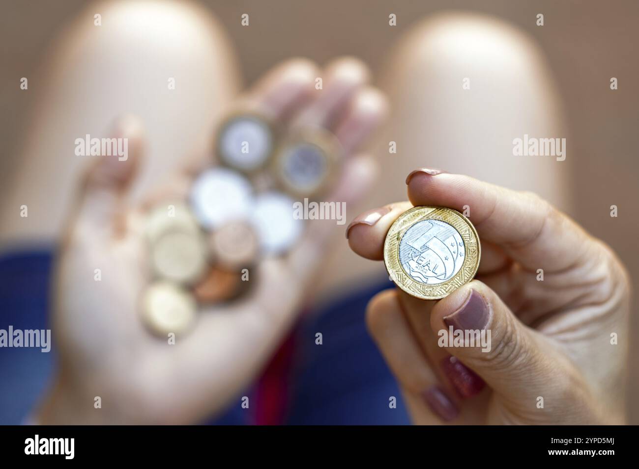 April 19, 2024, Brazil. Woman holds some real coins, Brazilian money ...