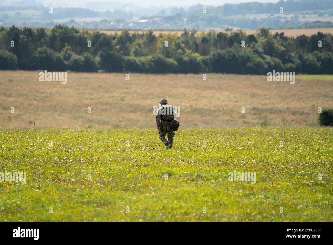 army soldier with gun on a 40kg loaded march tab military exercise ...