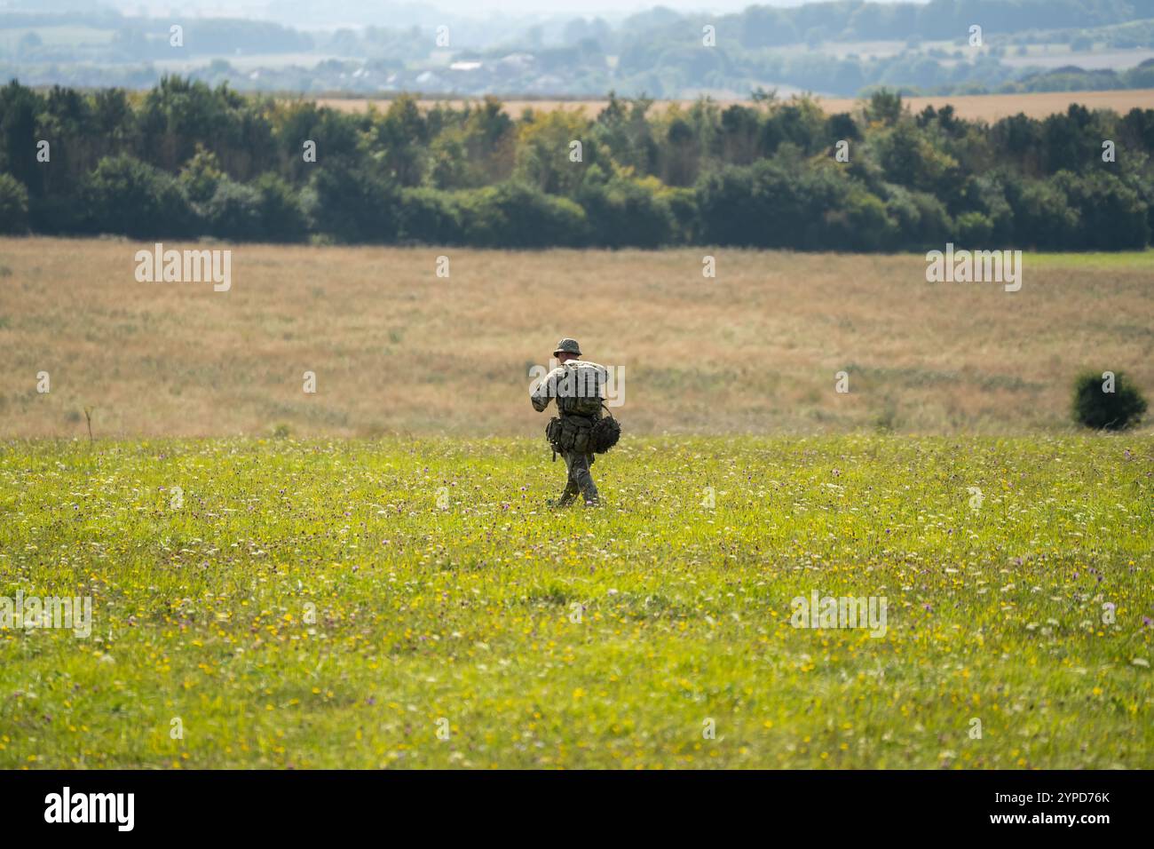 army soldier with gun on a 40kg loaded march tab military exercise ...