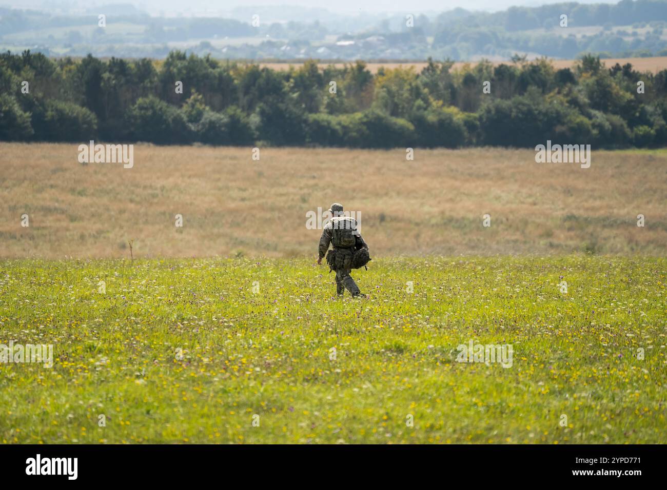 army soldier with gun on a 40kg loaded march tab military exercise ...