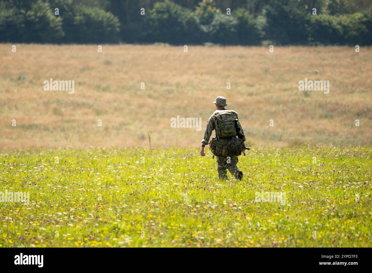 army soldier with gun on a 40kg loaded march tab military exercise ...