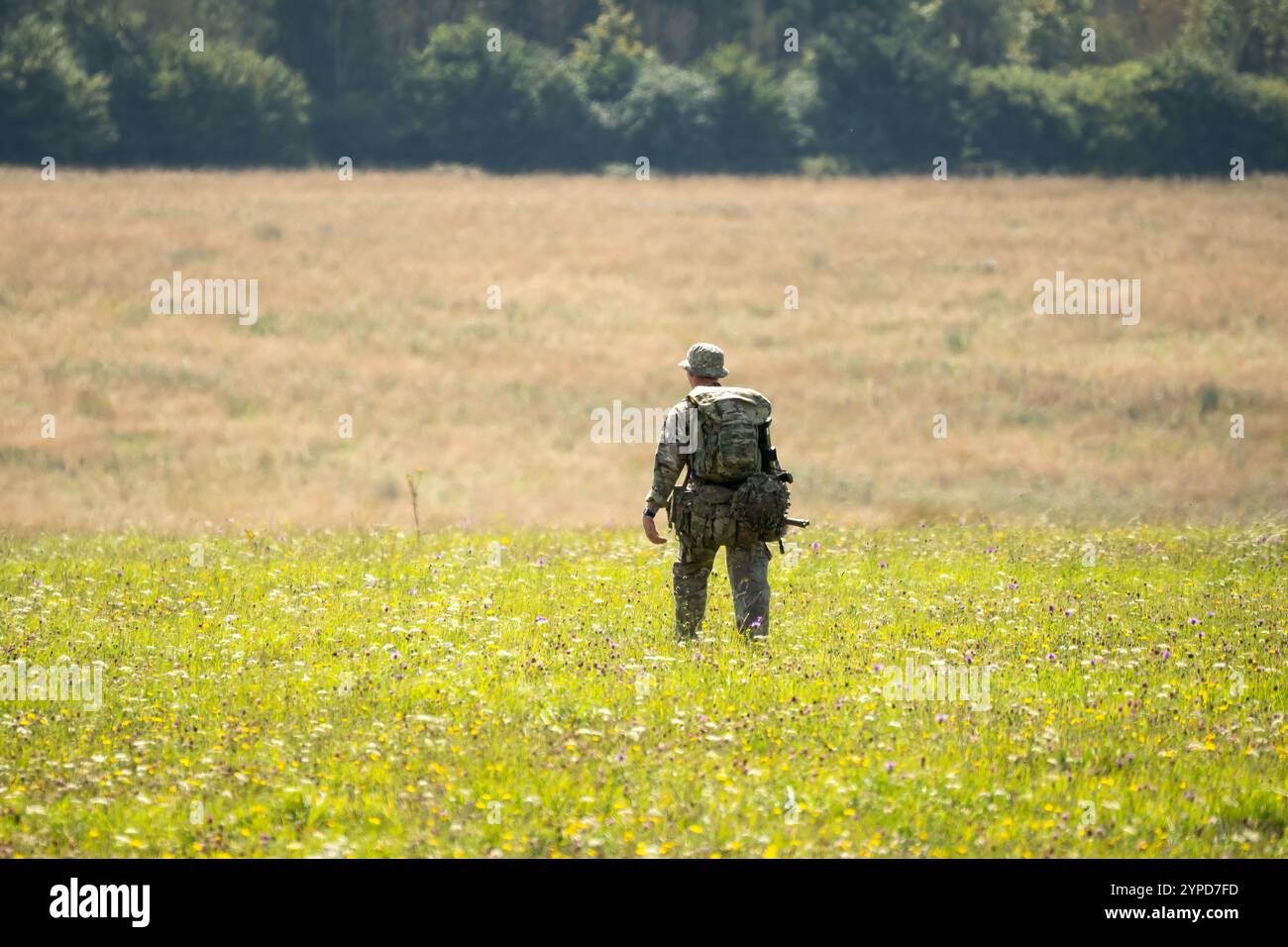 army soldier with gun on a 40kg loaded march tab military exercise ...