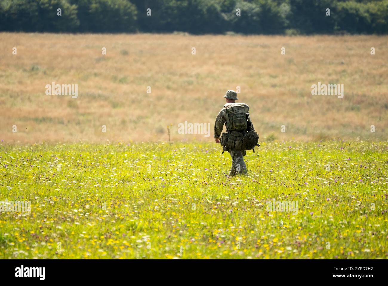 army soldier with gun on a 40kg loaded march tab military exercise ...
