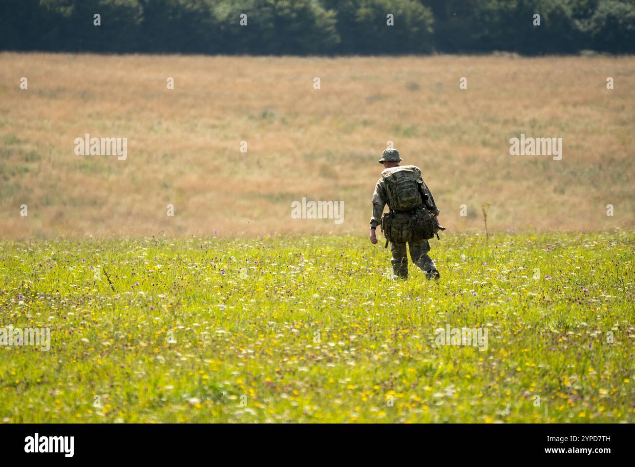 army soldier with gun on a 40kg loaded march tab military exercise ...