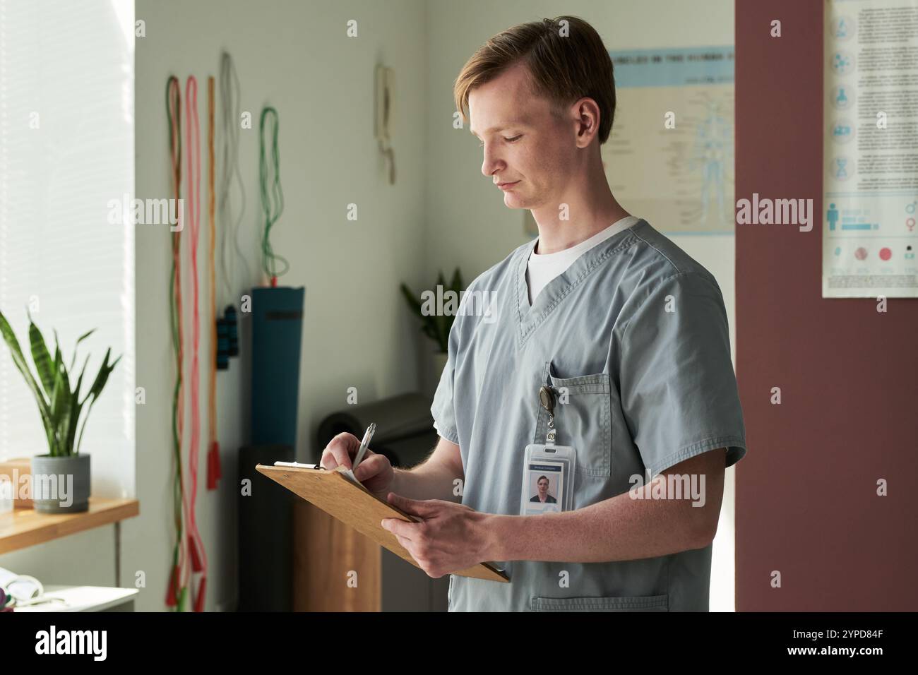 Medical professional standing in an office while reviewing patient ...