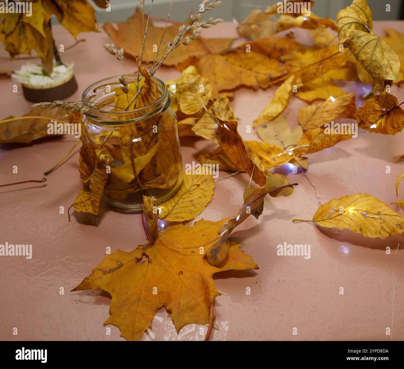 Autumn inspiration: leaves in a jar among the decor Stock Photo - Alamy