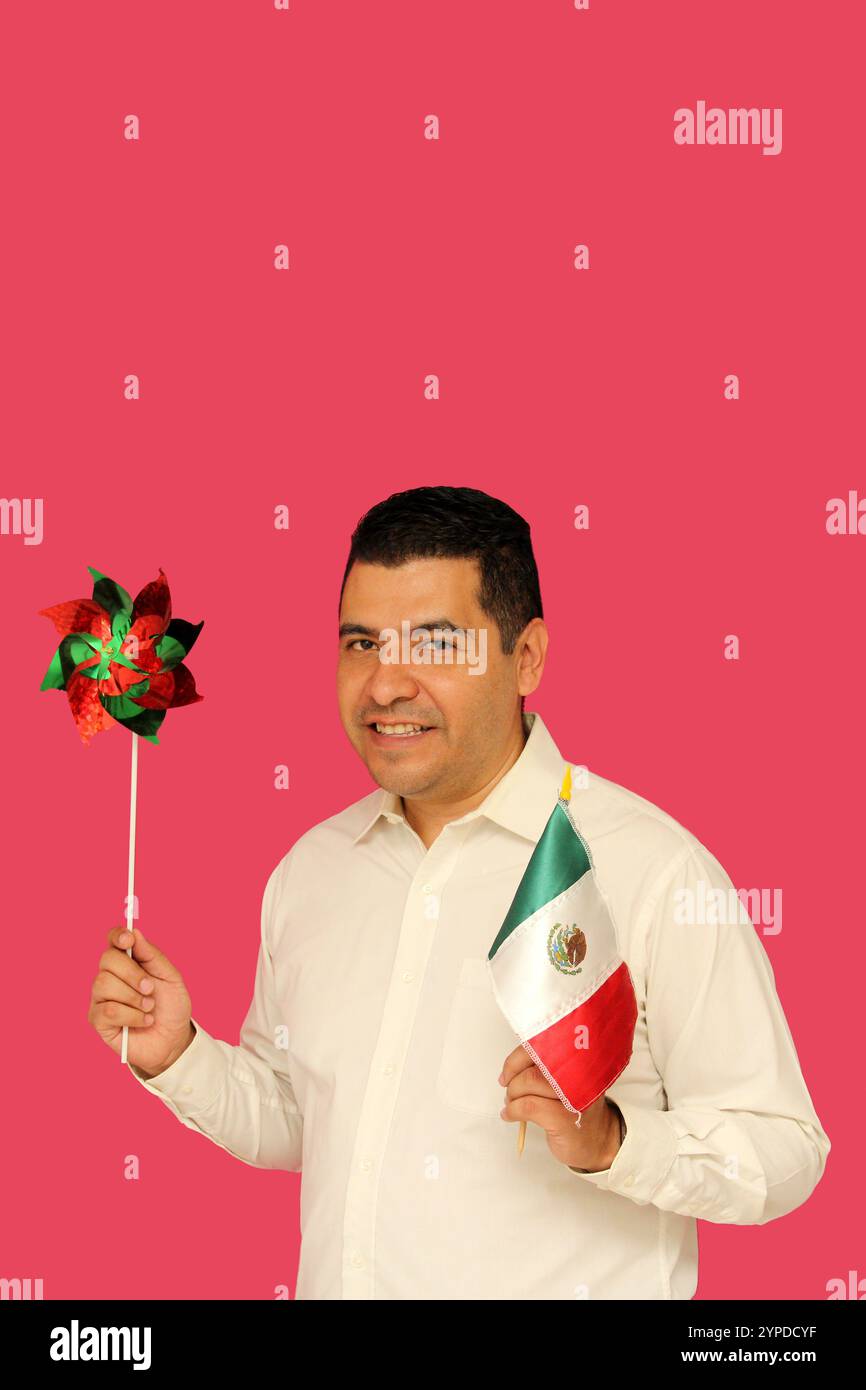 40-year-old dark-skinned Mexican man blows to spin a tricolor pinwheel ...