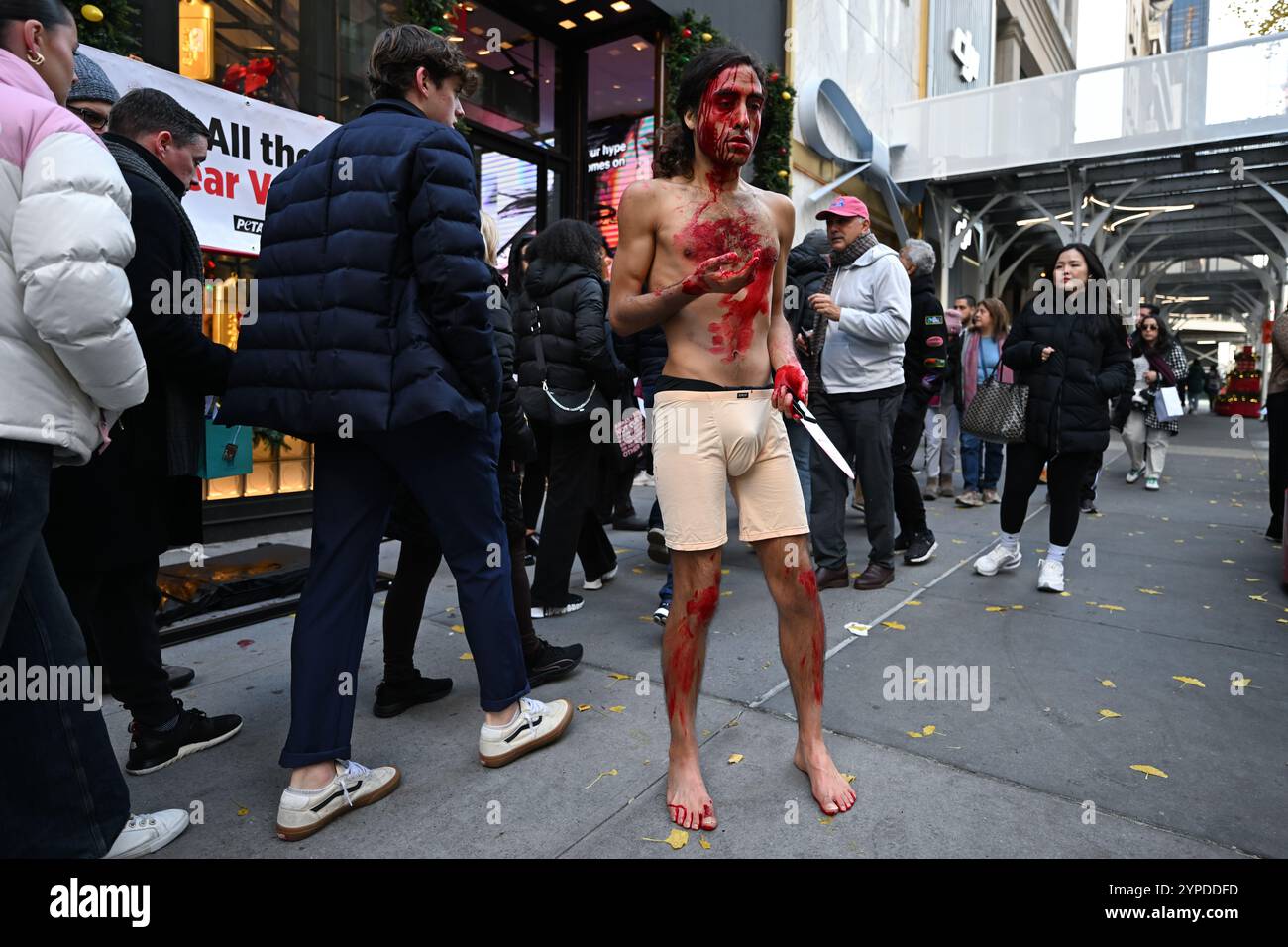 A 'skinned' PETA supporter protests outside the Coach store on Fifth ...