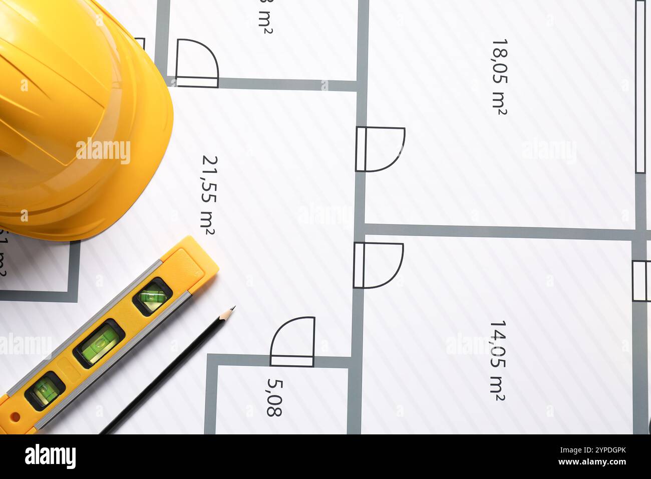 Pencil, hard hat and building level on different architectural drawings ...