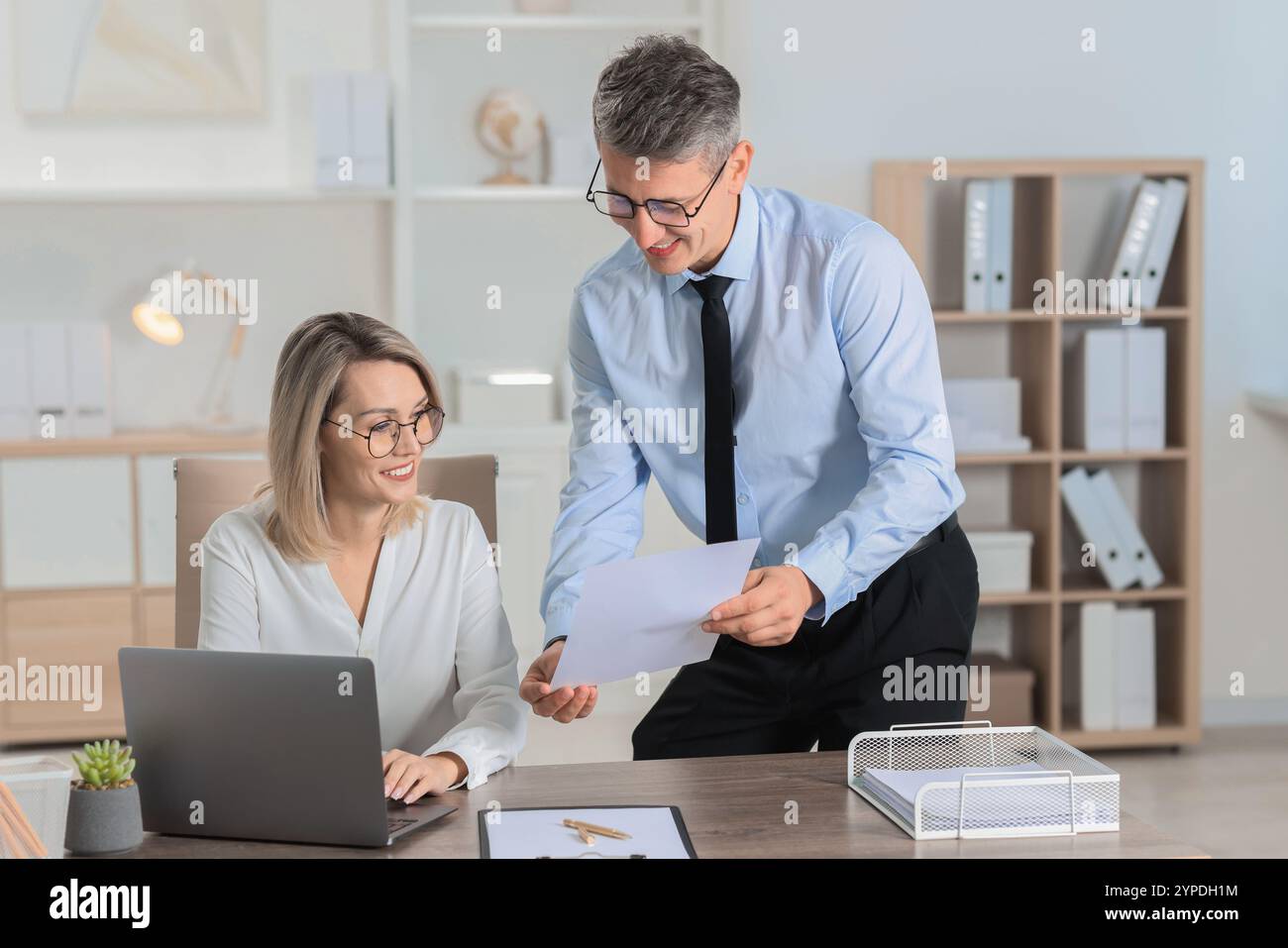 Middle aged employees working together in office Stock Photo - Alamy