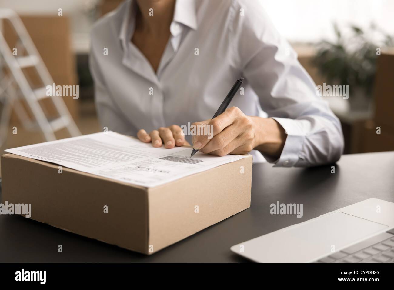 Delivery service employee sending package with purchase Stock Photo - Alamy