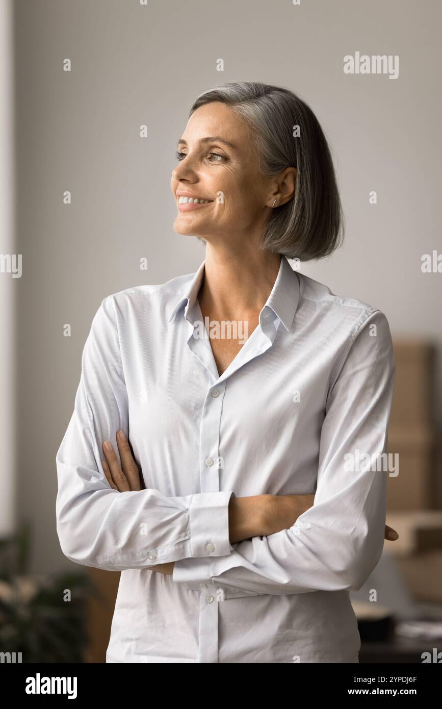 Happy dreamy mature business woman vertical portrait Stock Photo - Alamy