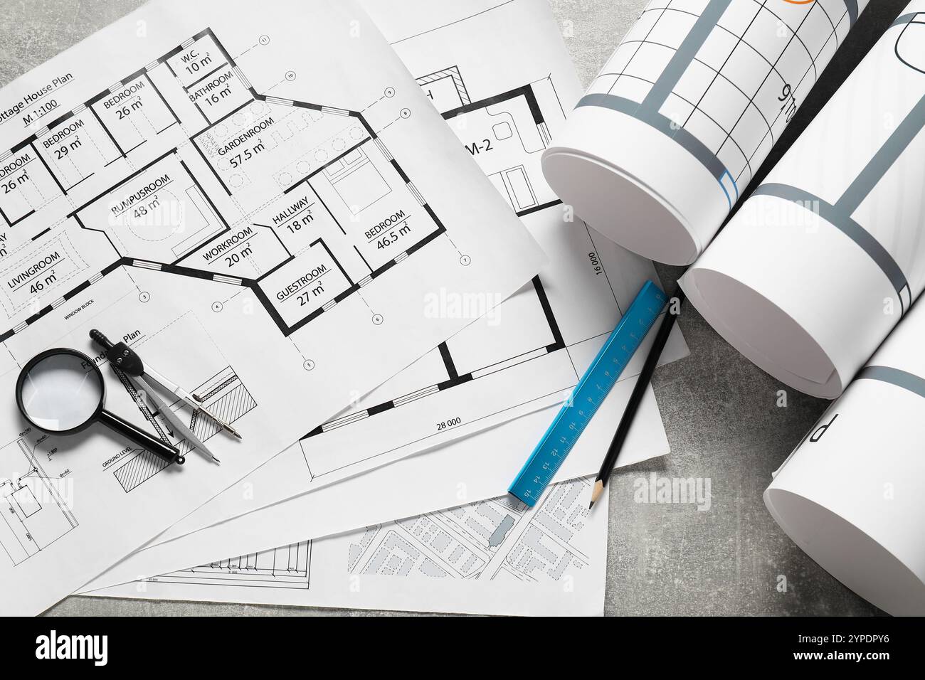 Different engineering drawings and tools on grey textured table, flat ...