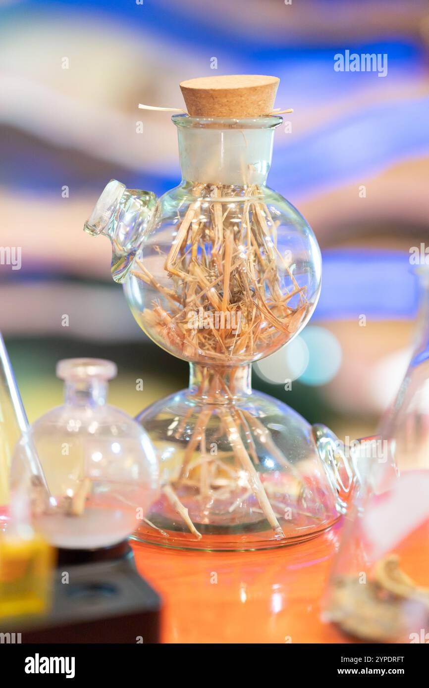 Magic laboratory. Distinctive glass apparatus filled with straw is ...