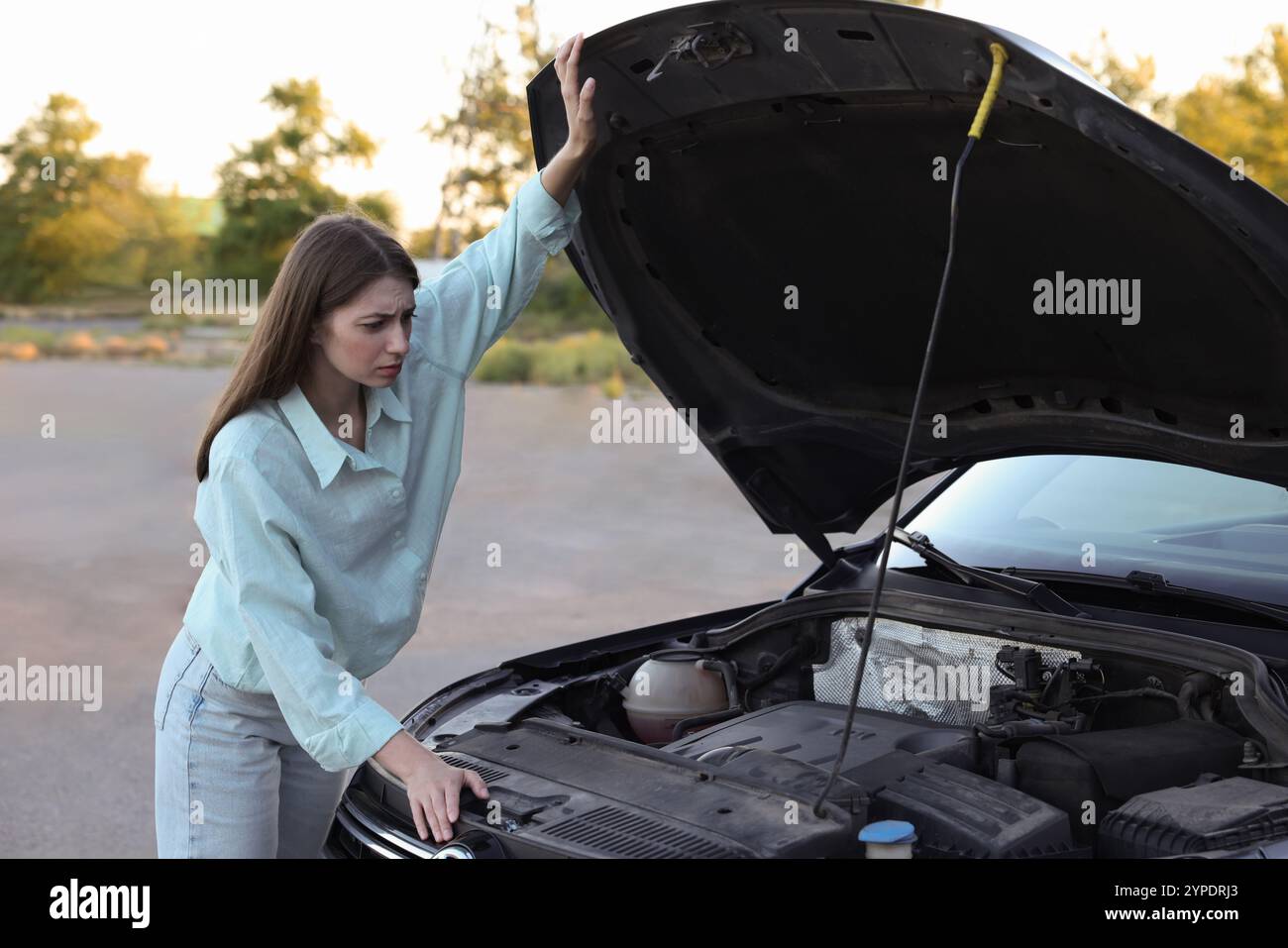 Woman looking under hood car hi-res stock photography and images - Alamy