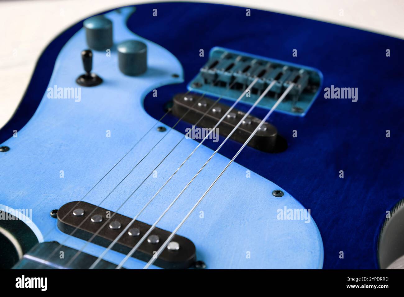 Blue electric guitar on white background, closeup. Musical instrument ...
