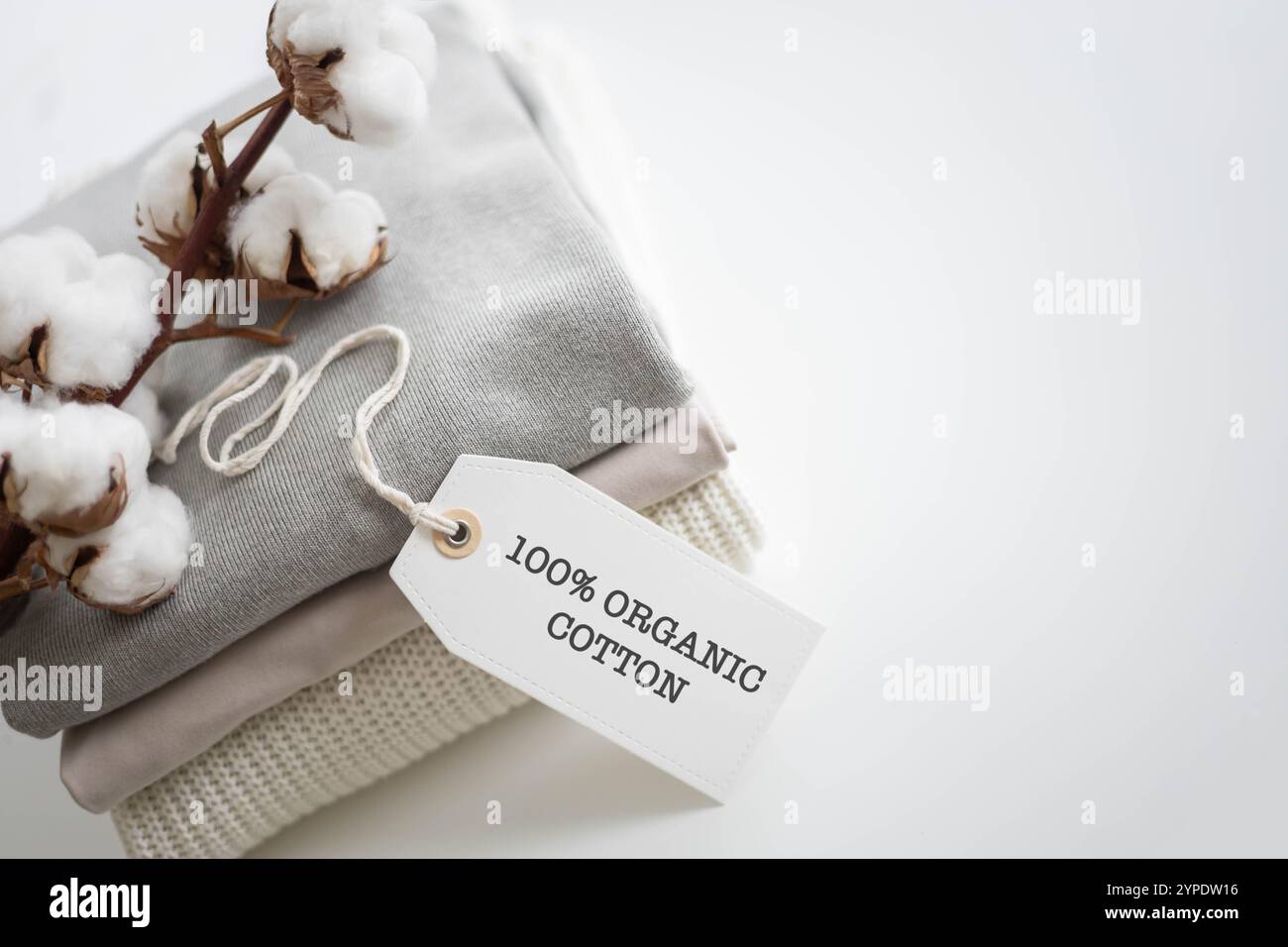 A neat stack of knitted clothing labeled 100 percent organic cotton ...