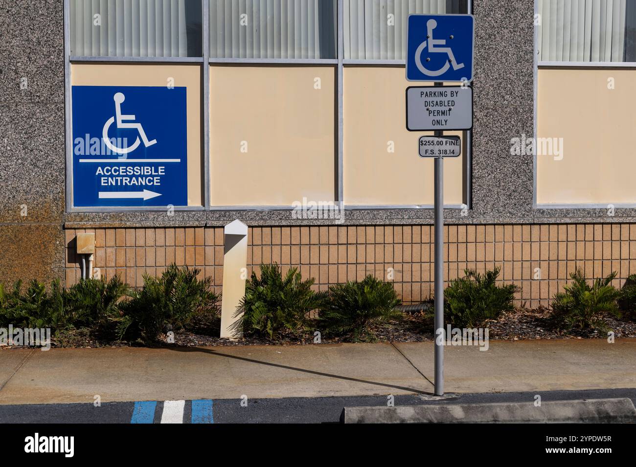 Sign on the street indicating the access route for disabled people ...
