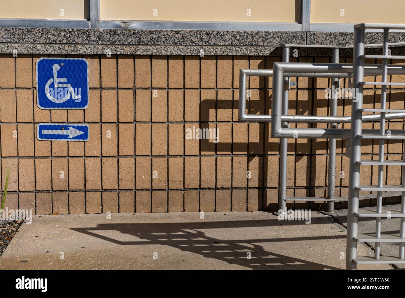 Sign on the street indicating the access route for disabled people ...