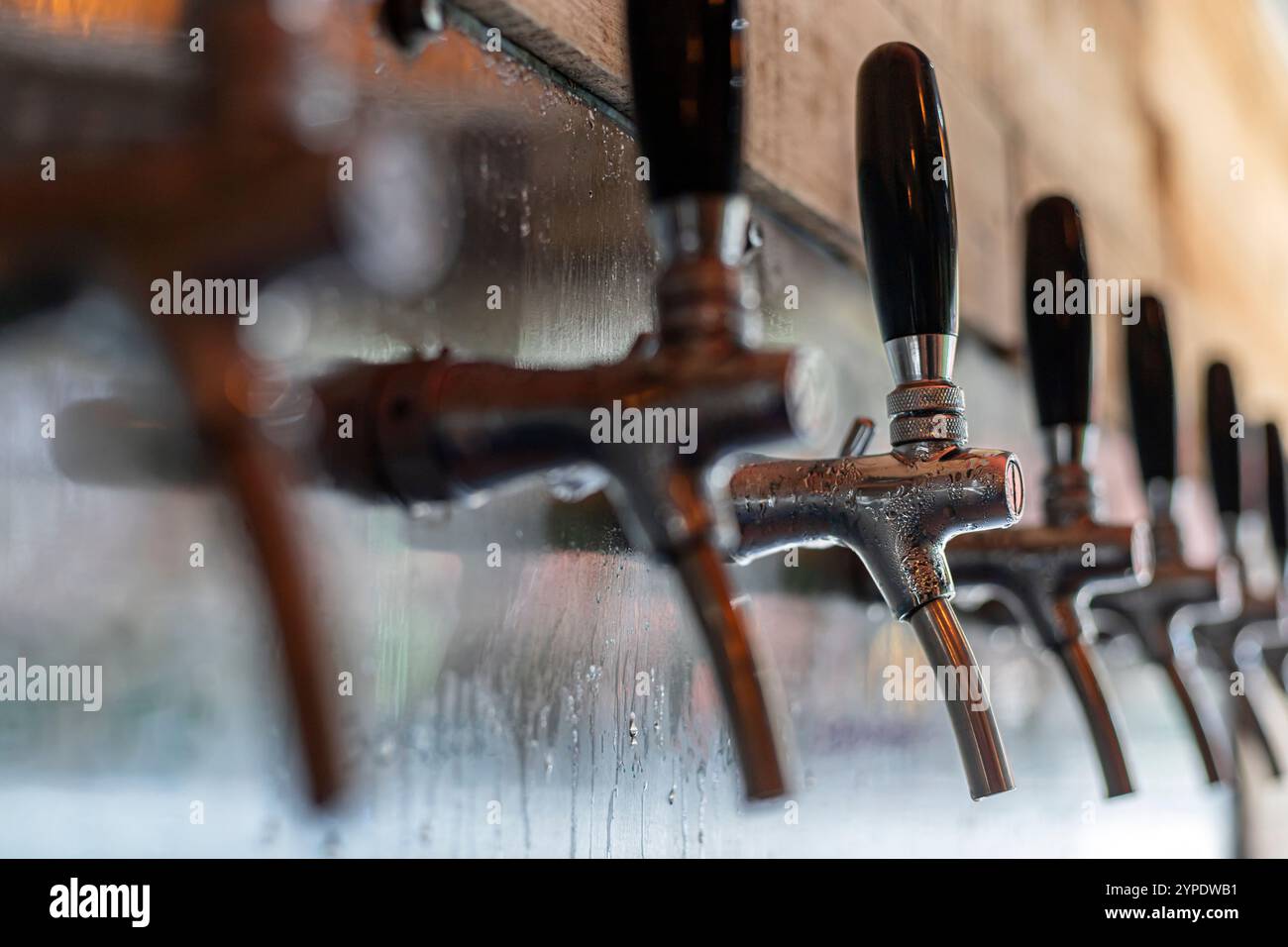 Selective focus of a group of beer taps in a bar Stock Photo - Alamy