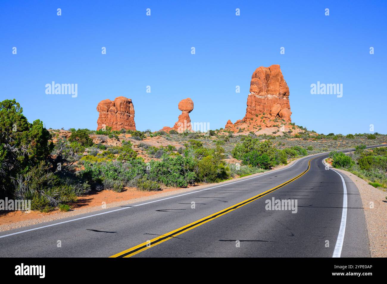 Balanced Rock in Arches National Park under blue sky with road Stock ...